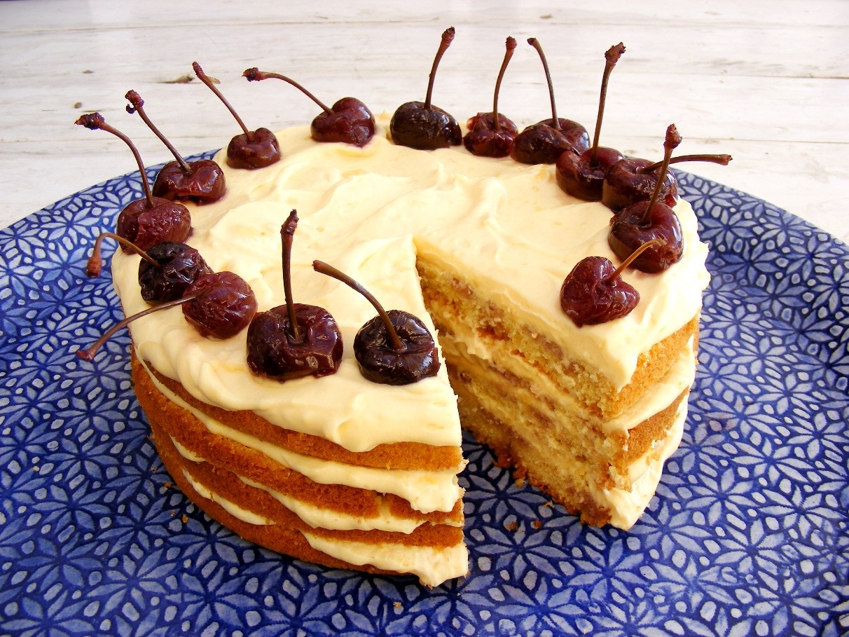 Custard and cream layer cake with brandied cherries